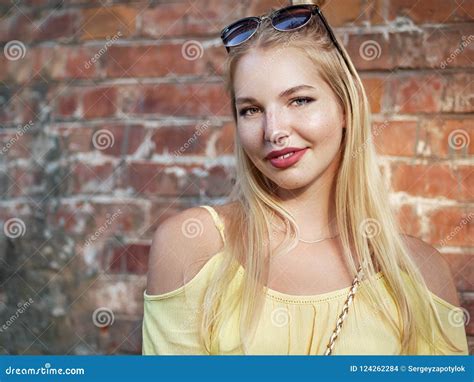 Close Up Portrait Of Young Beautiful Blonde Woman With High Bun