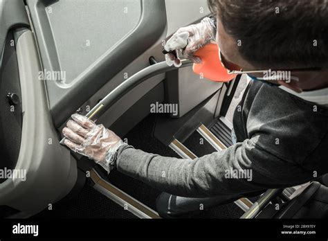 Caucasian Intercity Bus Driver Sanitizing Railings Using Alcohol In