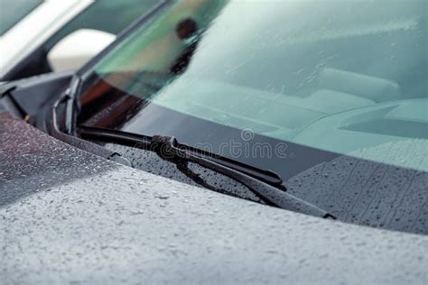 Car Wiper Cleaning Water Drops From Windshield Glass Closeup Stock