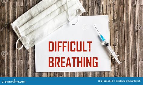 Difficulty Breathing The Word Is Written On A White Piece Of Paper And A Wooden Board Stock