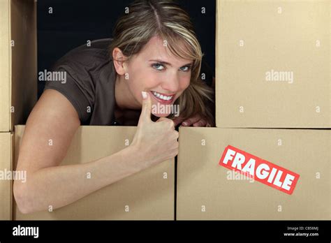Woman Stood Amongst Fragile Boxes Stock Photo Alamy