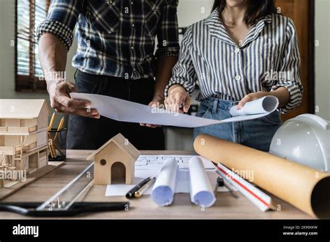 Architect Man Working With Blueprints For Architectural Plan Engineer Sketching A Construction