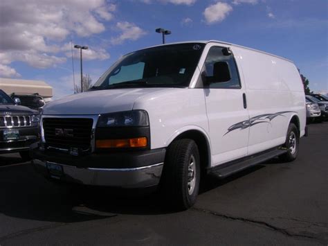 A White Van Parked In A Parking Lot A White Van Parked In A Parking Lot