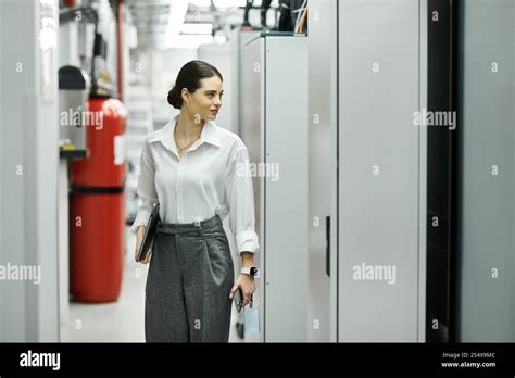 A Professional Woman Works Diligently In A Contemporary Server Room