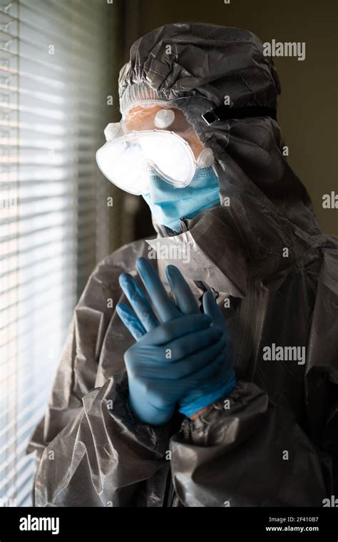 Worried Doctor Or Lab Technician Scientist In PPE Personal Protective Equipment Near A Hospital