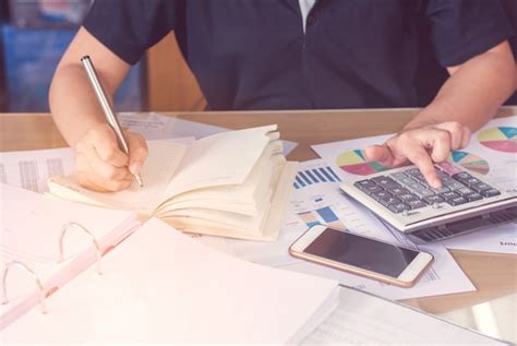 Premium Photo Woman Hand Using Calculator And Writing Make Note With Calculate