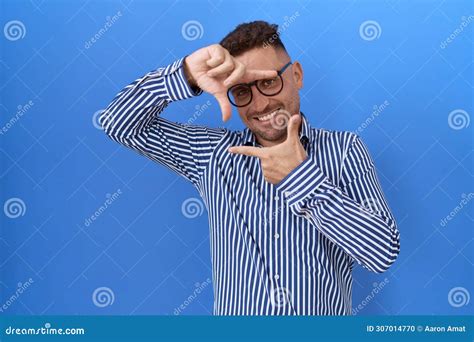 Hispanic Man With Beard Wearing Glasses Smiling Making Frame With Hands