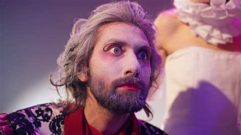 Astonished Caucasian Man With Theatrical Makeup Looking Away With