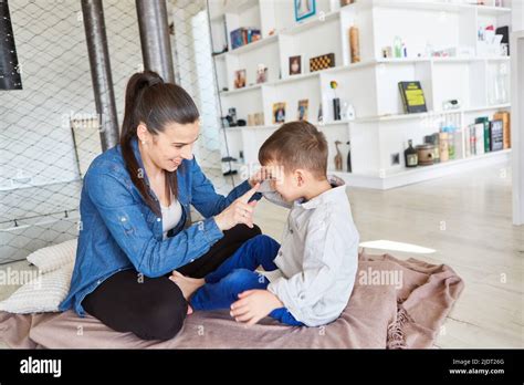 Mother Teasing Her Son With Index Finger While Playing At Home In The