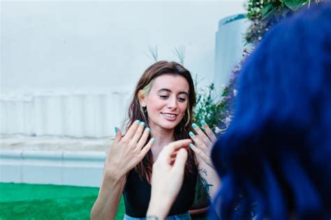 Premium Photo Happy Young Women Playing Patty Cake In Backyard
