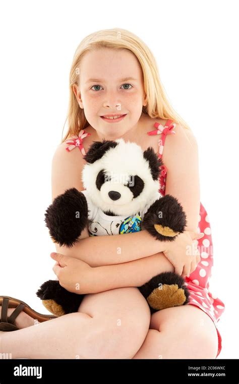 Close Up Of Beautiful Young Blonde Girl Cuddling Her Teddy Bear And