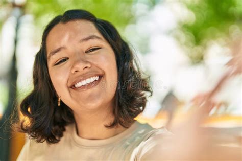 Young Woman Smiling Confident Making Selfie By The Camera At Park Stock