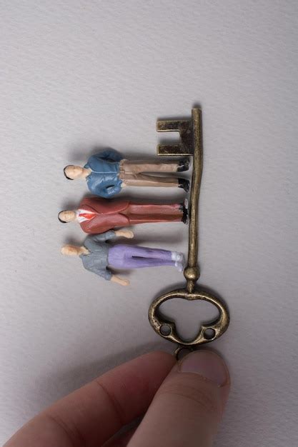 Premium Photo Tiny Figurine Of Man Miniature And Retro Key