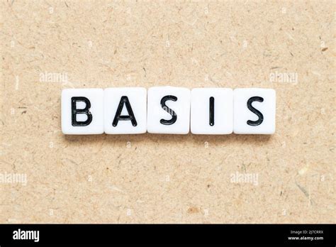 white tile alphabet letter with word basis on wood background stock
