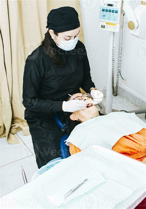 Dentist With Patient Lying Down Dentist Examining Mouth To Patient Woman Dentist Doing