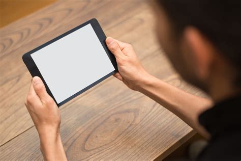 Close Up Image Of A Man Using A Digital Tablet Wallit