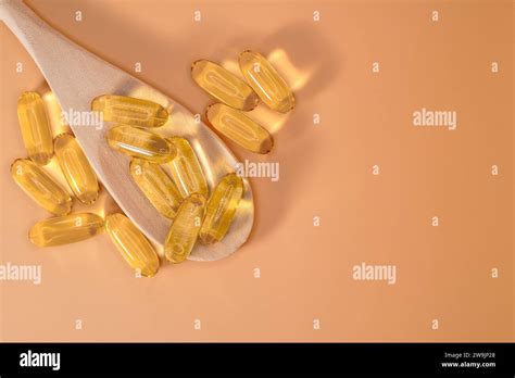 Omega 3 Fish Oil Gel Capsules On A Neutral Peach Background Cod Liver