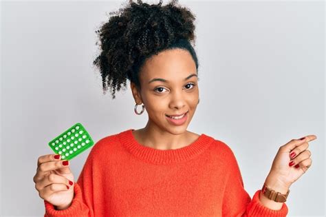 Premium Photo Young African American Girl Holding Birth Control Pills