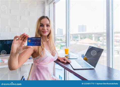 Girl Sitting Smiling And Hand Holding Credit Card With Happiness Stock