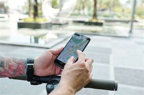 Premium Photo Close Up Image Of Man Checking Navigation Map On Smartphone Before Riding On Scooter