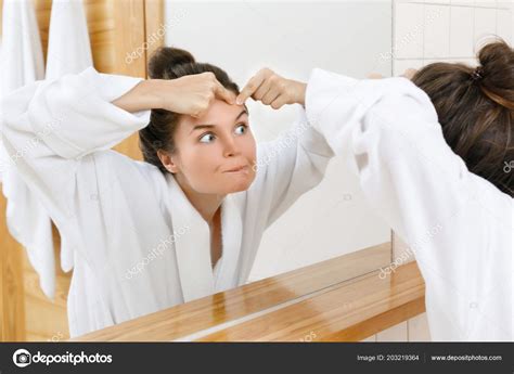Woman Squeeze Pimples Bathroom Stock Photo AY PHOTO 203219364