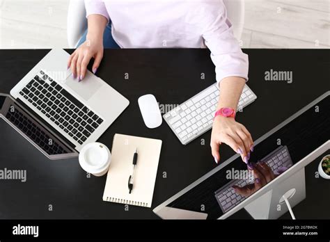Female Programmer Working With Laptop And Computer In Office Stock