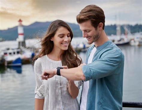 Premium Photo Woman Showing Smart Watch To Babefriend At Harbour