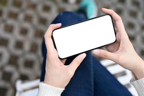 Premium Photo Top View Of A Womans Hands Holding A Smartphone White