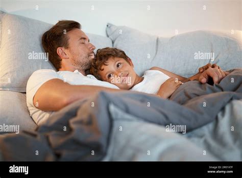 Looks Like Dad Had A Long Day A Man And His Son Lying In A Bed