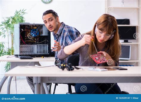 Two Technicians Working At Computer Warranty Center Stock Image Image