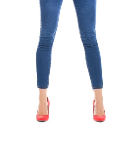 Premium Photo Slim Female Legs In High Heels And Jeans On White Background