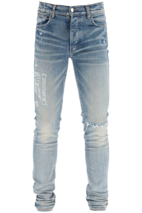 Amiri Distressed Logo Jean In Blue Modesens