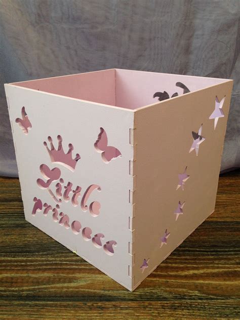 A White Box With Pink And Purple Designs On The Inside Sitting On A