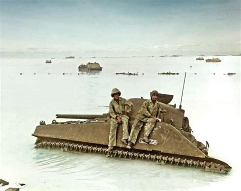 Two Marines Sit Atop The M4a2 Sherman Cecilia” Who Provided Red Beach