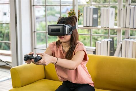 Asian Woman Playing Video Games With Controller With Virtual Glasses