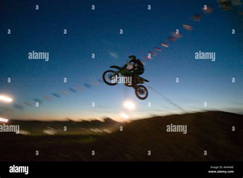 A Dirt Bike Goes Airborne During A Jump On A Motocross Course In
