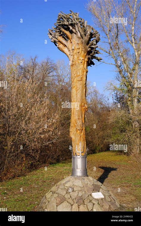 Carved Wooden Tree Trunk Pillar At The Confluence Of The Main Branch Of