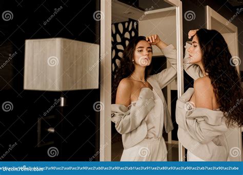 Model And Her Reflection In The Mirror Attractive Girl Near The Mirror