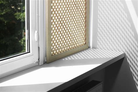 Empty White Window Sill And Decorative Wooden Shutter Indoors Stock