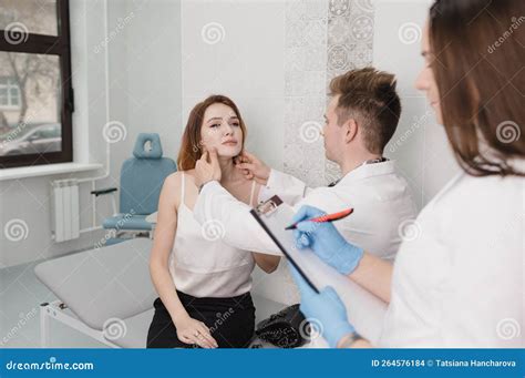 A Doctor And A Nurse Examine A Patient In The Clinic Sitting On A Couch