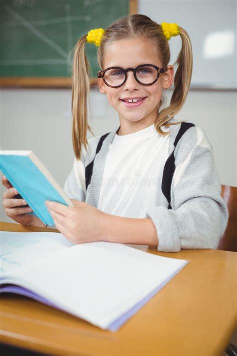 Smiling Pupil Reading Book At Her Desk Stock Image Image Of