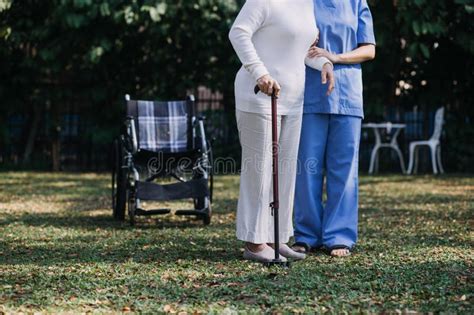 Asian Young Caregiver Nurse Support Senior Older Male Walking Outdoors Specialist Girl Doctor