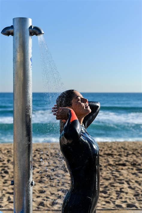Female Standing Under Shower On Beach By Stocksy Contributor Bisual