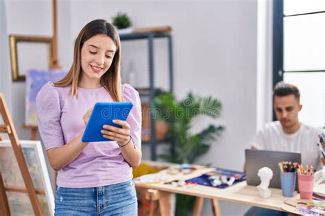Man And Woman Artists Couple Using Laptop And Touchpad Drawing At Art