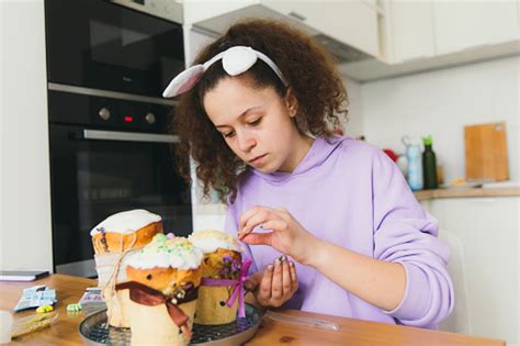 토끼 귀에 젊은 여자와 귀여운 개는 휴일을 축하하는 부엌에서 부활절 케이크를 장식 18 19세에 대한 스톡 사진 및 기타 이미지 18 19세 가정 생활 가정 주방