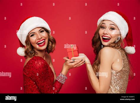 Close Up Portrait Of Two Beautiful Joyful Women In Christmas Hats