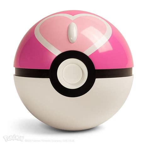 A Pink And White Ball With A Heart On The Top Is Sitting In Front Of A