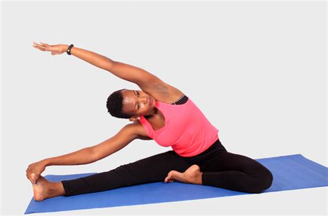 Flexible Woman Exercising Stretching While Sitting On Yoga Mat High Quality Free Stock Images
