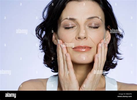 A Woman Touching Her Cheeks Sensually Stock Photo Alamy