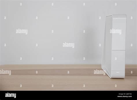 Modern White Wi Fi Router On Table Near Light Wall Stock Photo Alamy